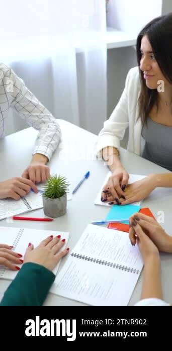 Vertical Screen: college male and female students having teamwork ...