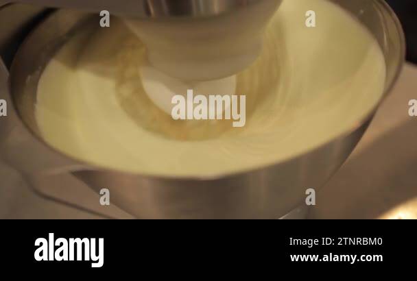 Whip the cream with an electric whisk. The work of a professional ...