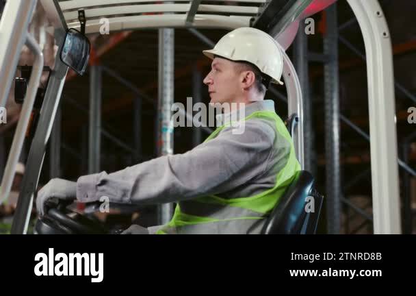 Logistic Guy Caucasian Worker Operating Forklift at Logistic Center ...