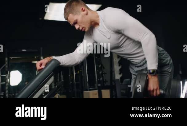 Bodybuilder man with athletic body training arms and back muscules and ...