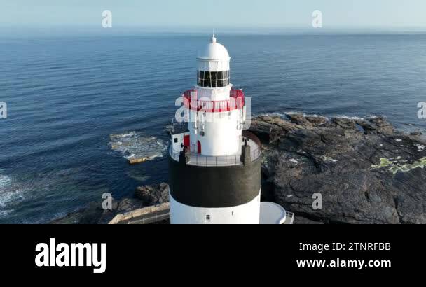 A majestic lighthouse with an ocean backdrop. Hook Lighthouse is ...