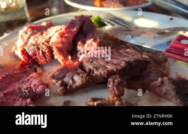 Food Waste at Thanksgiving. throws meat scraps and chicken bones into a ...