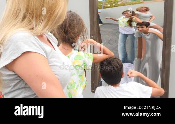 Mom and her children, Twins boy and girl takes a reflection in a false ...