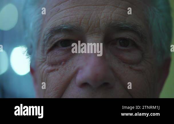 Macro close-up of a stern serious senior elderly man staring at camera ...