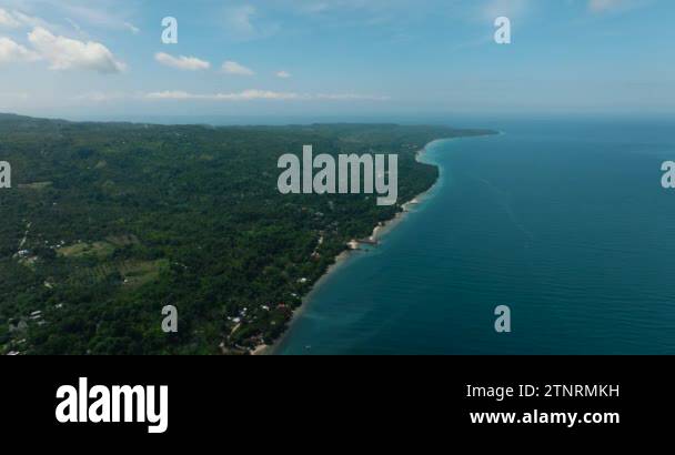Tropical island with greenery forest and blue sea. Blue sky and clouds ...