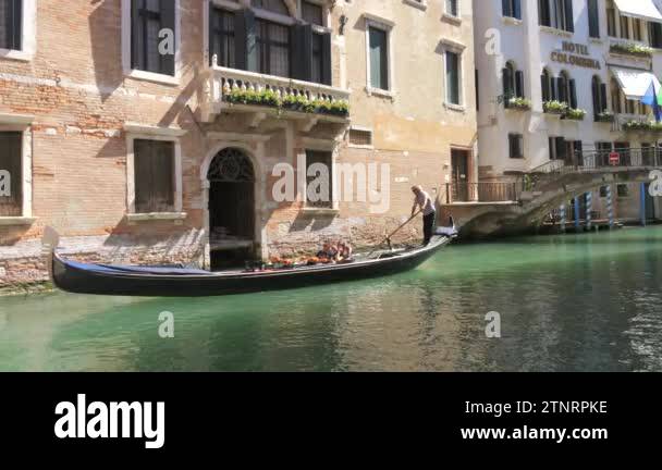 Venice, Italy - September 6, 2023: Gondola float on a narrow canal ...