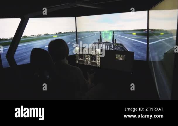 Back view of short-haired lady using flight simulator for practicing ...