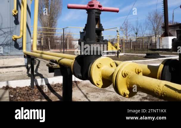 Yellow gas pipe with a valve at the gas distribution station. Natural ...
