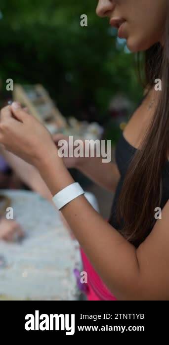 An exuberant girl with rosy wristbands on her arms is fitting a ...