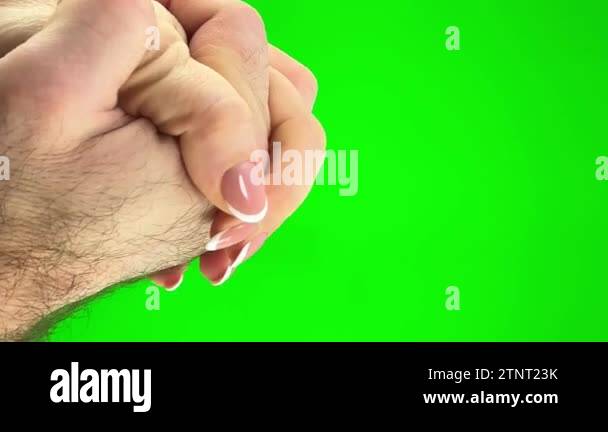 two hands male and female on a green background chromakey meet crossed ...