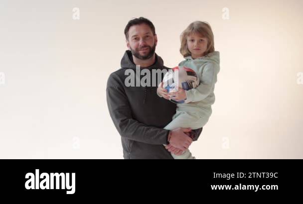 Portrait of a happy handsome dad with his son in his arms. Happy fairy ...