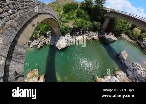 Drone view of the Mesi Bridge, located in Albania, is an architectural ...