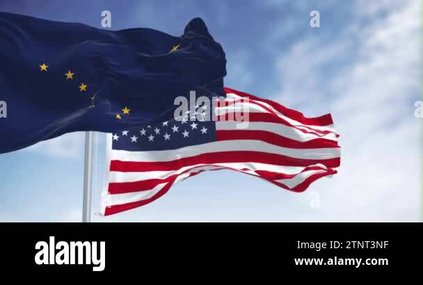 Alaska state flag waving in the wind with the national flag of the ...
