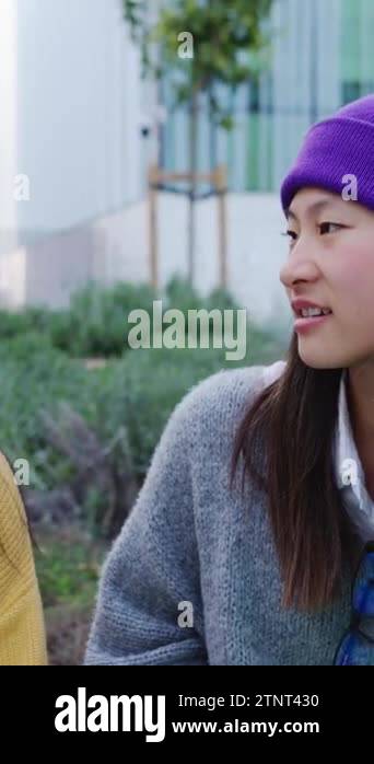 Young group of asian gen z student friends chatting together sitting at ...