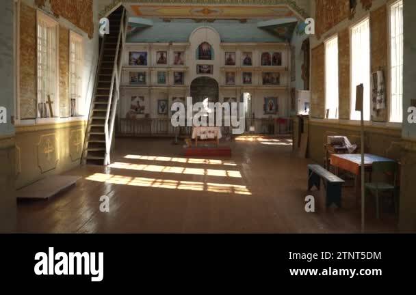 A wide view reveals an altar adorned with numerous icons in an ...