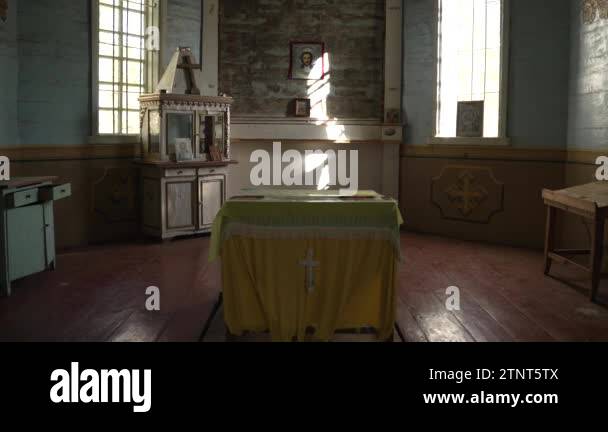 Zoom in view of an abandoned Orthodox church reveals large windows ...