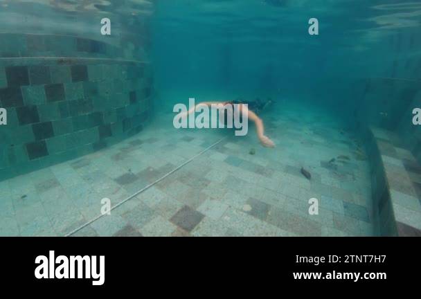 Freediver trains in the pool. Woman freediver works out in the pool ...