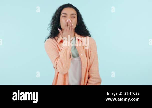 Woman, face and blow kiss in studio for love, romance and happy ...