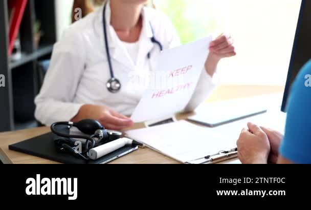 Paper with words keep health and female doctor with stethoscope ...
