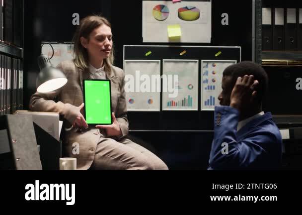 Female inspector speaking with policeman while vertically holding ...