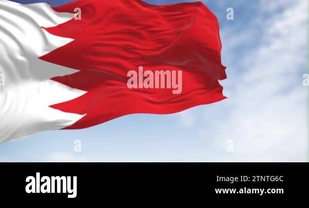 National flag of Bahrain waving on a clear day. White band on the left ...