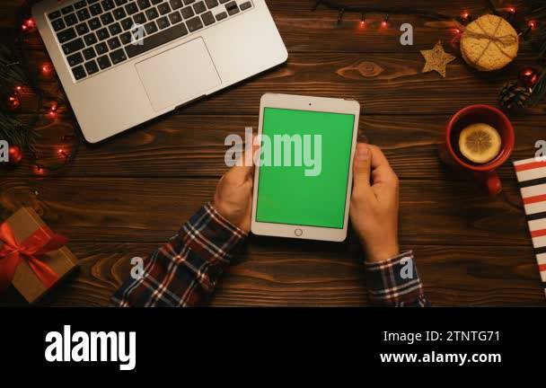 Man scrolling pages on the tablet computer touchscreen. Green screen ...