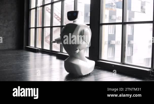 Humanoid autonomous robot near the window. The robot shows emotions ...