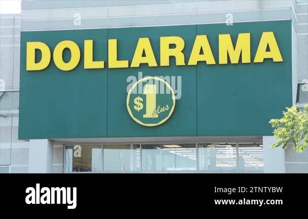 dollarama sign logo on front of store with windows and door opening ...