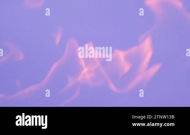 Gentle pink flames on a purple background. Slow-motion video of fire ...