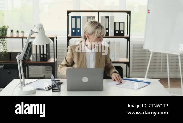 Skilled businesswoman is shown multitasking efficiently in her office ...