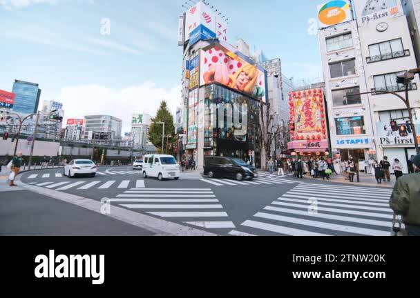 Tokyo, Japan - Dec 2, 2022: Crowded people walk cross road, car traffic ...