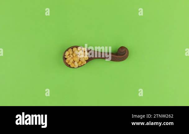 Zoom of a clay spoon with dry peas grain. Chroma key, green screen ...