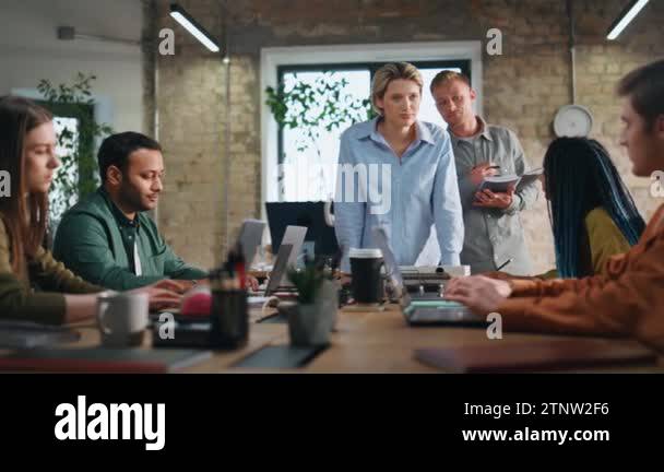 Female boss explaining strategy company to colleagues in conference ...