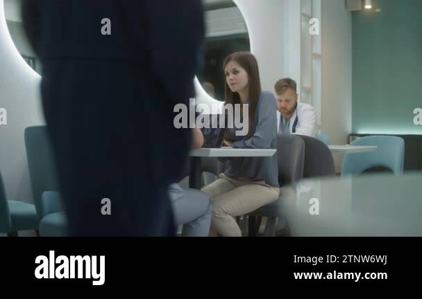Female doctor sits in clinic cafe with patient. Professional medic ...