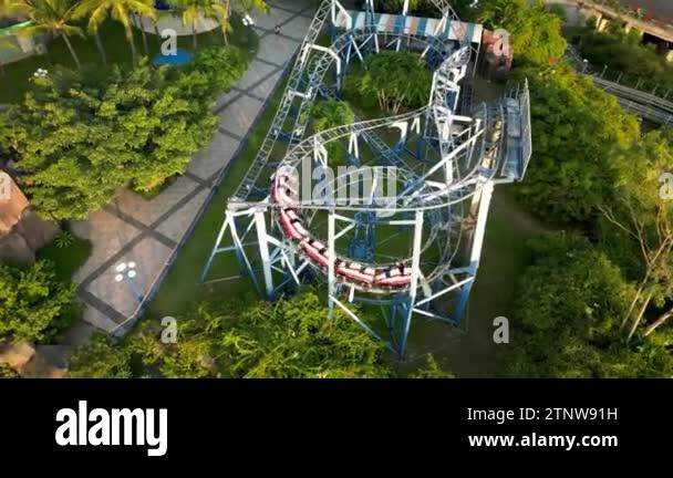 Beautiful top view pov shot of twisting red and blue roller coaster ...