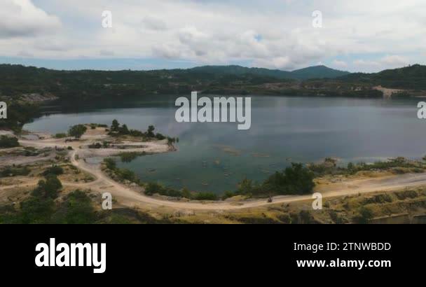 Mining quarry with flooded bottom. Lake with blue water near sand pit ...