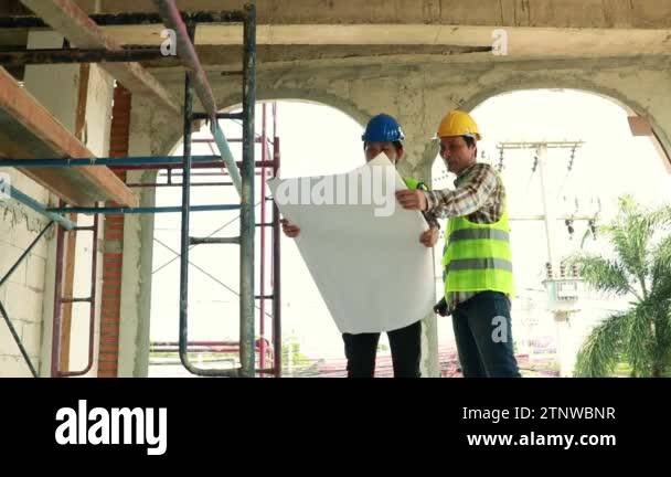 Asian business architects team Engineers with building design ...