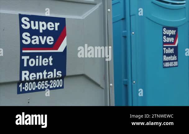 two porta portable potties next to each other, one gray and one blue ...