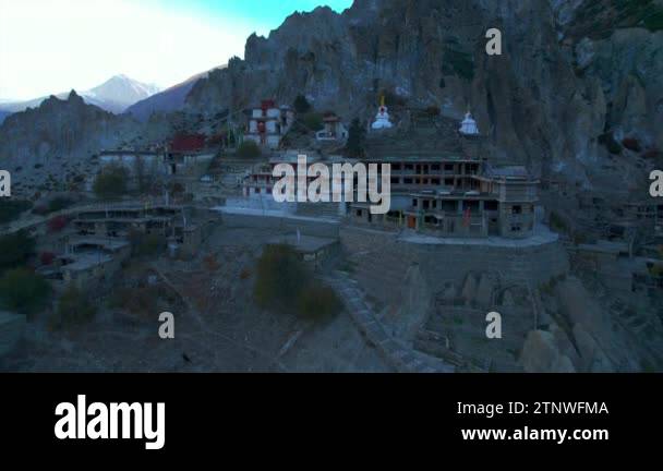 Backwards reveal of mountain hotel resort in Himalayas. Traditional ...