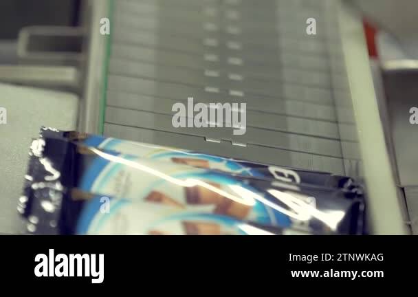 static slow motion close up shot of packer removing packaged chocolate ...