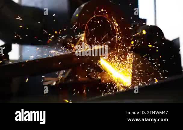 Cutting a metal using cutting machine and the fire sparks splashes ...