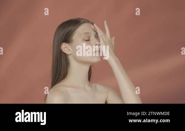 A Young Seminude Woman Touches A Clean Moisturized Face Profile