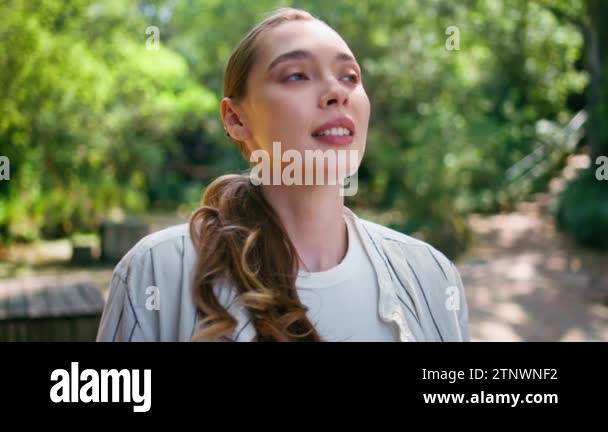 Portrait of dreamy beautiful woman standing in green forest alone ...