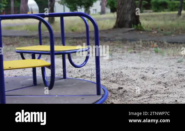 Multi-colored childrens carousel in childrens park is spinning and ...