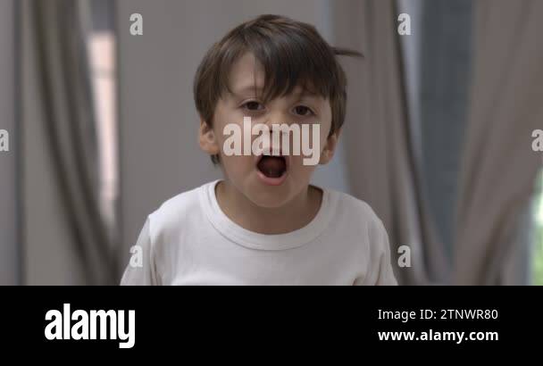 Upset child emotion in slow-motion. Close-up of angry little boy ...