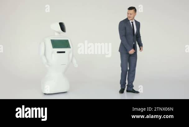 Humanoid autonomous robot dancing with stylish man in a suit. Modern ...
