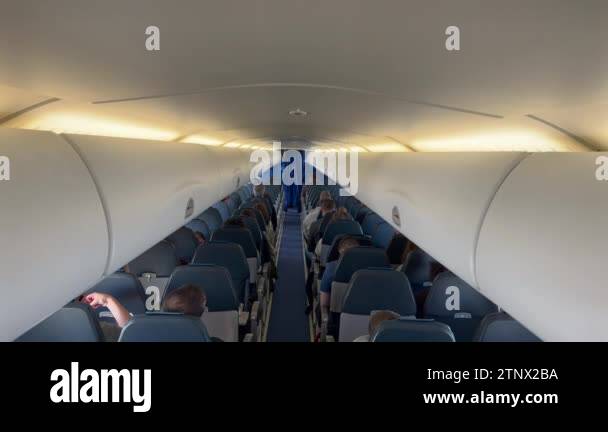 Back of Aircraft ceiling inside plane cabin. Passengers seen from above ...