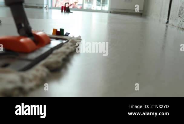 A woman washes the floor with a mop. Mop close-up while cleaning the ...