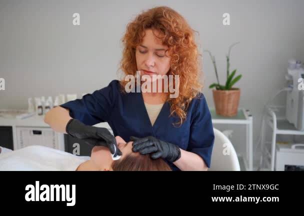 Aesthetic cosmetology. Master apply anesthetize on eyebrow. Permanent ...