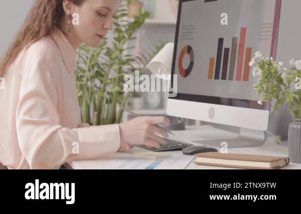 Professional female marketing specialist analyzing charts and diagrams ...